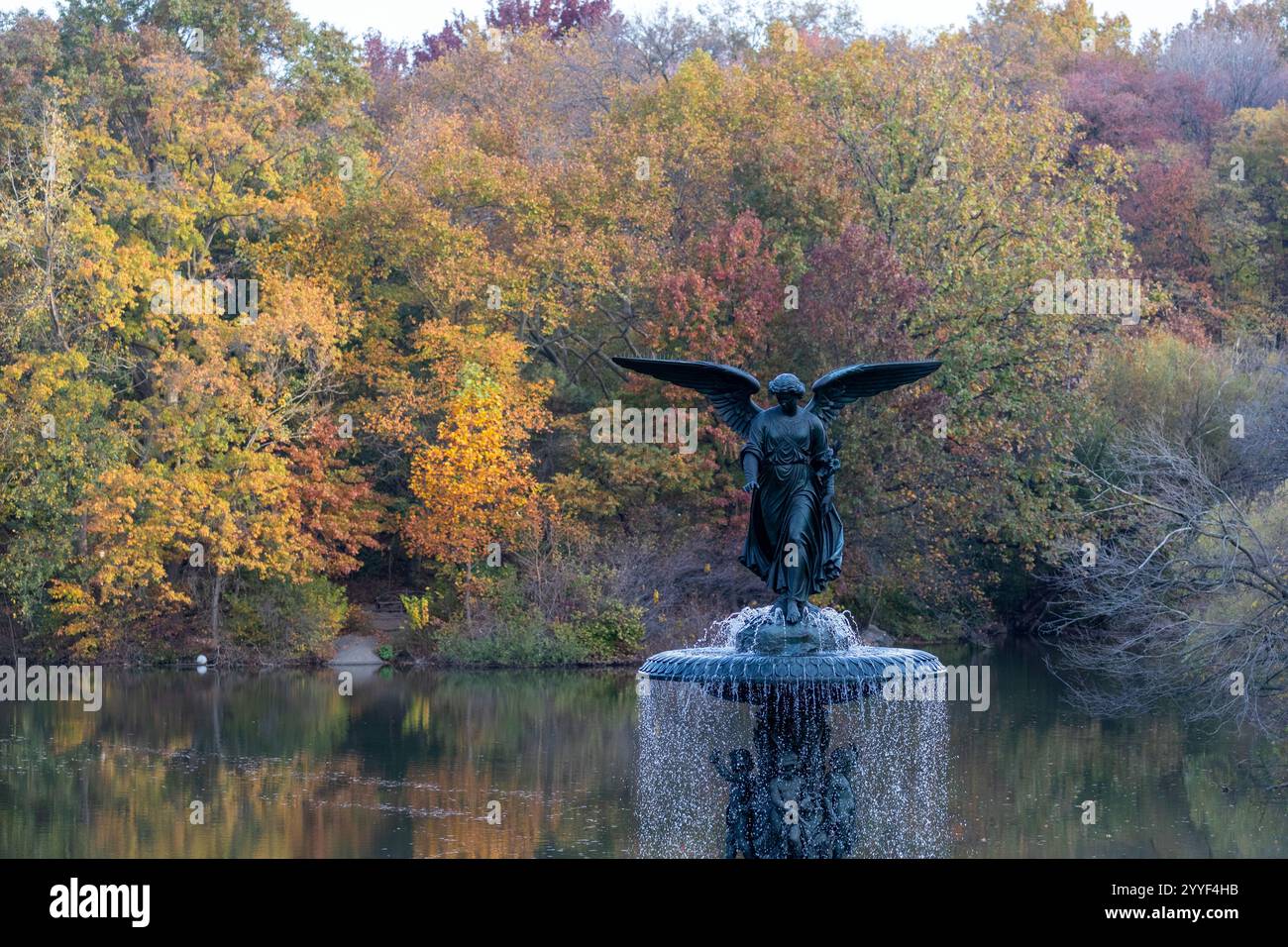 New York, USA - Nov 4 2024: Angel fountain, water pond and autumn ...