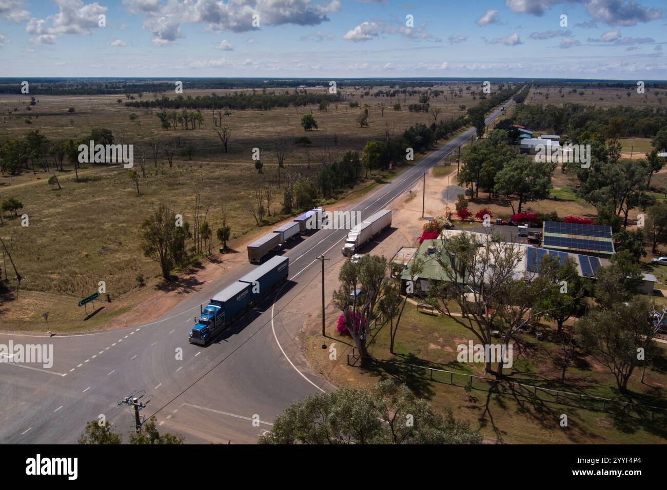 Aerial of Road Trains passing the Westmar Roadhouse on the Moonie ...