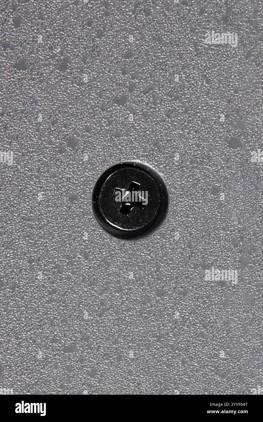 Close-up of black screw of electronic device case. Screw of laptop case ...