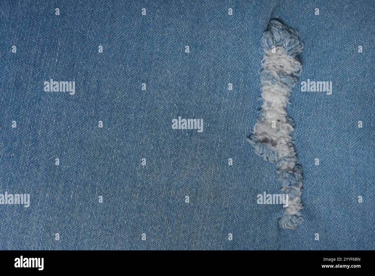 Ripped blue hipster jeans material. Destroyed denim Cloth texture ...