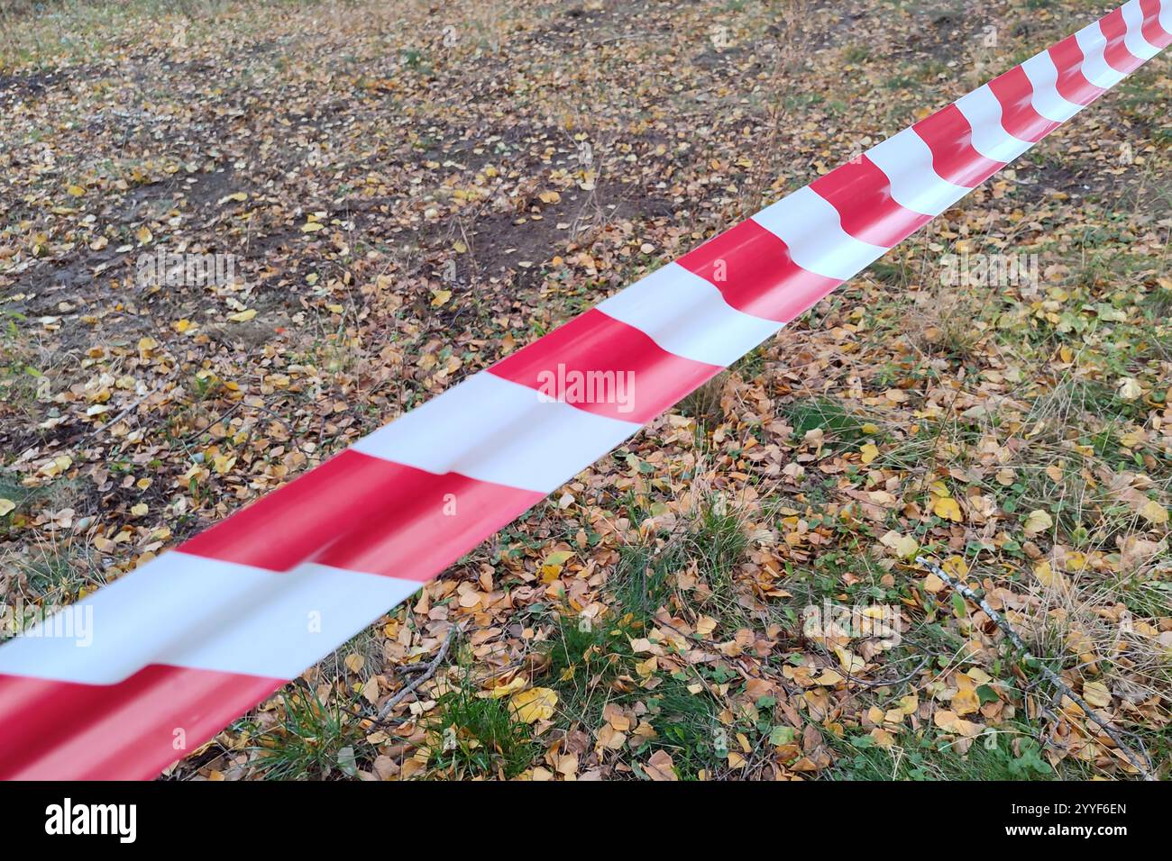 Red and white lines of barrier fencing tape. Fencing red and white tape ...