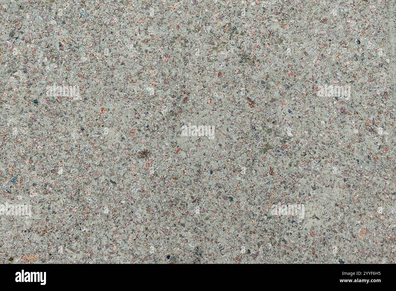 Concrete texture. Pebbles of different colors and signs of aging are ...
