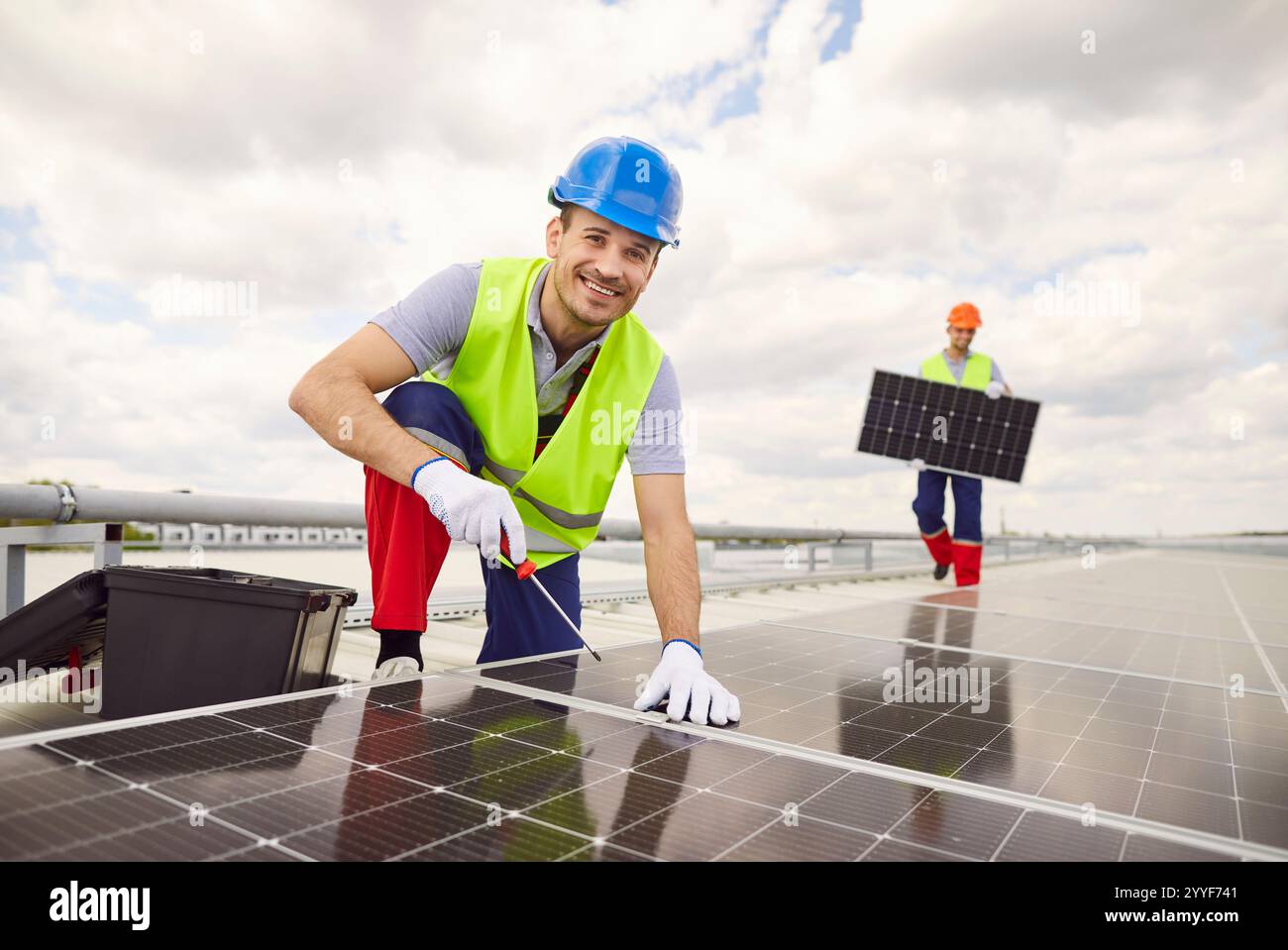 Portrait Of Smiling Worker Installing Or Servicing Solar Panels On Roof ...