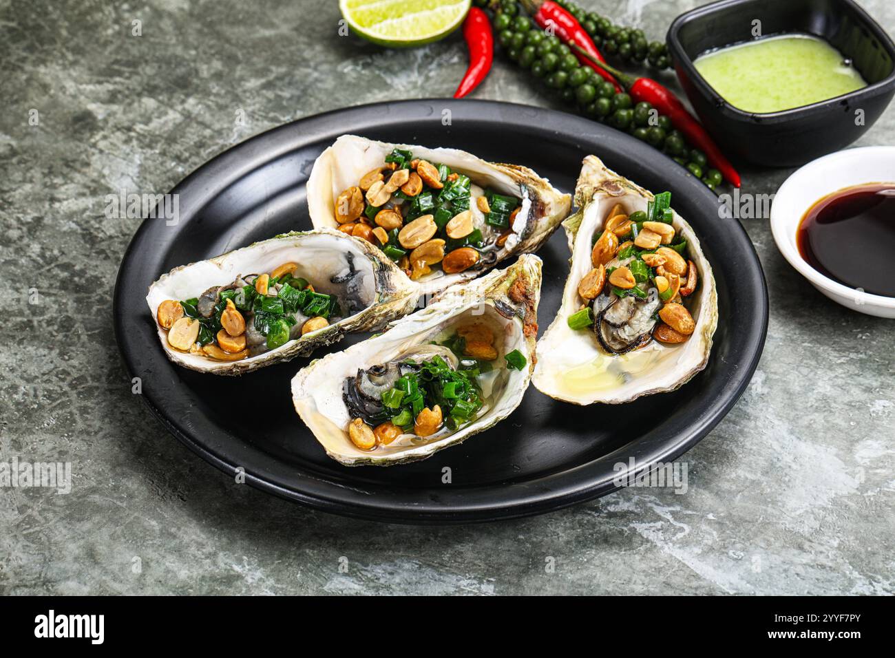 Open half oysters with green onion and peanut Stock Photo - Alamy