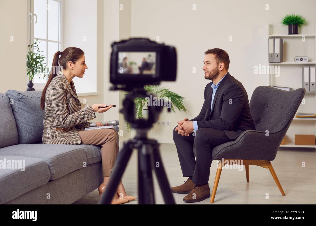 Female Reporter Interviewing Guest On Camera For Tv Show Stock Photo - Alamy