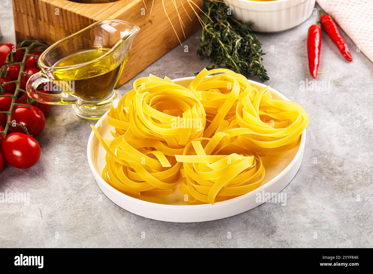 Raw dry Italian pasta - pappardelle for bowl Stock Photo - Alamy
