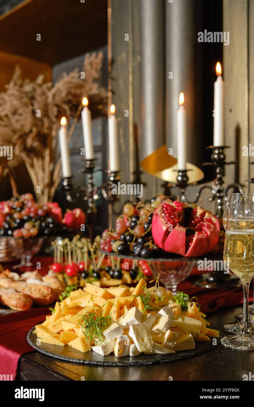 A beautifully arranged dining table features an assortment of cheeses ...