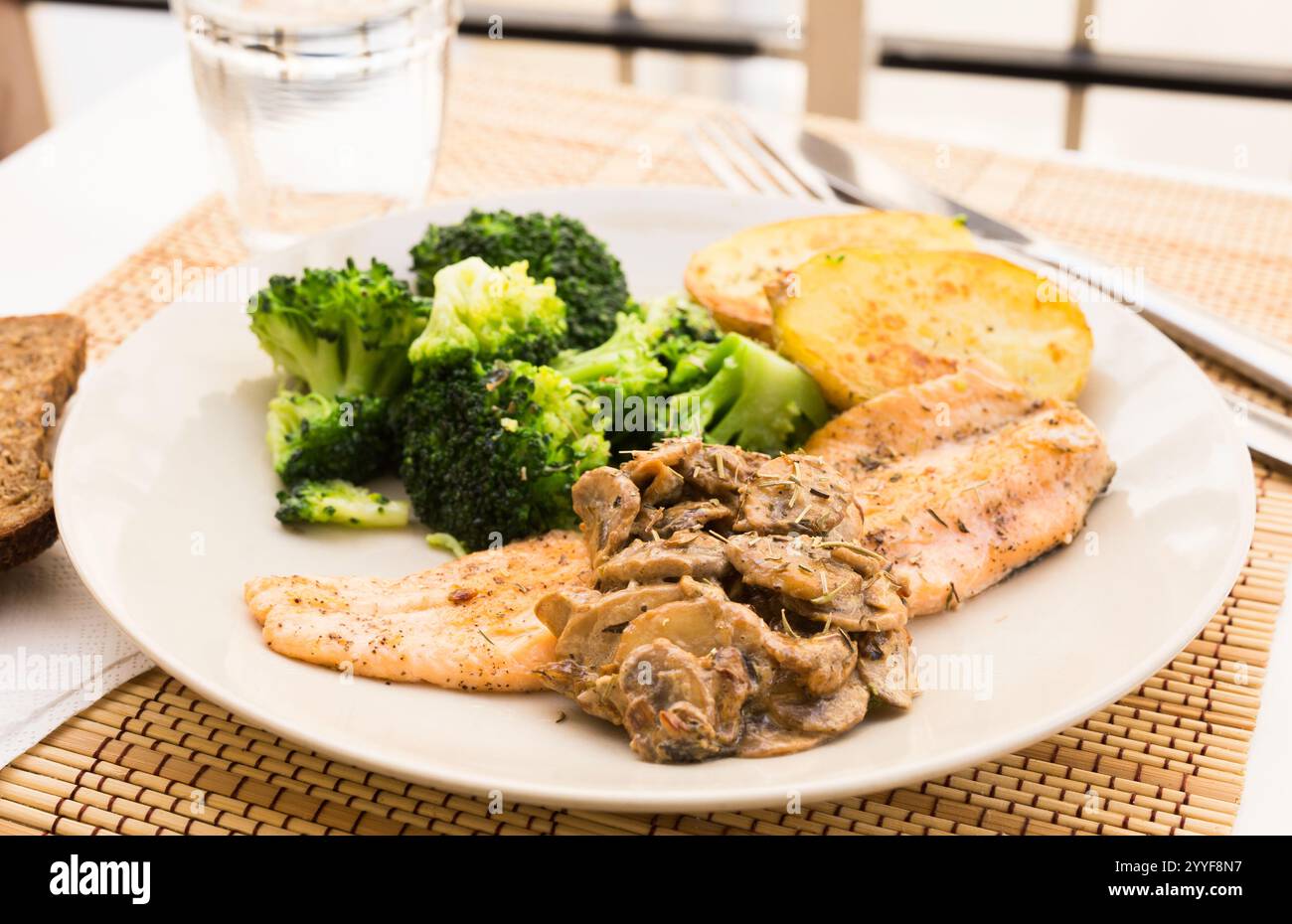 Fried river trout fillet with a complex side dish of broccoli, baked ...