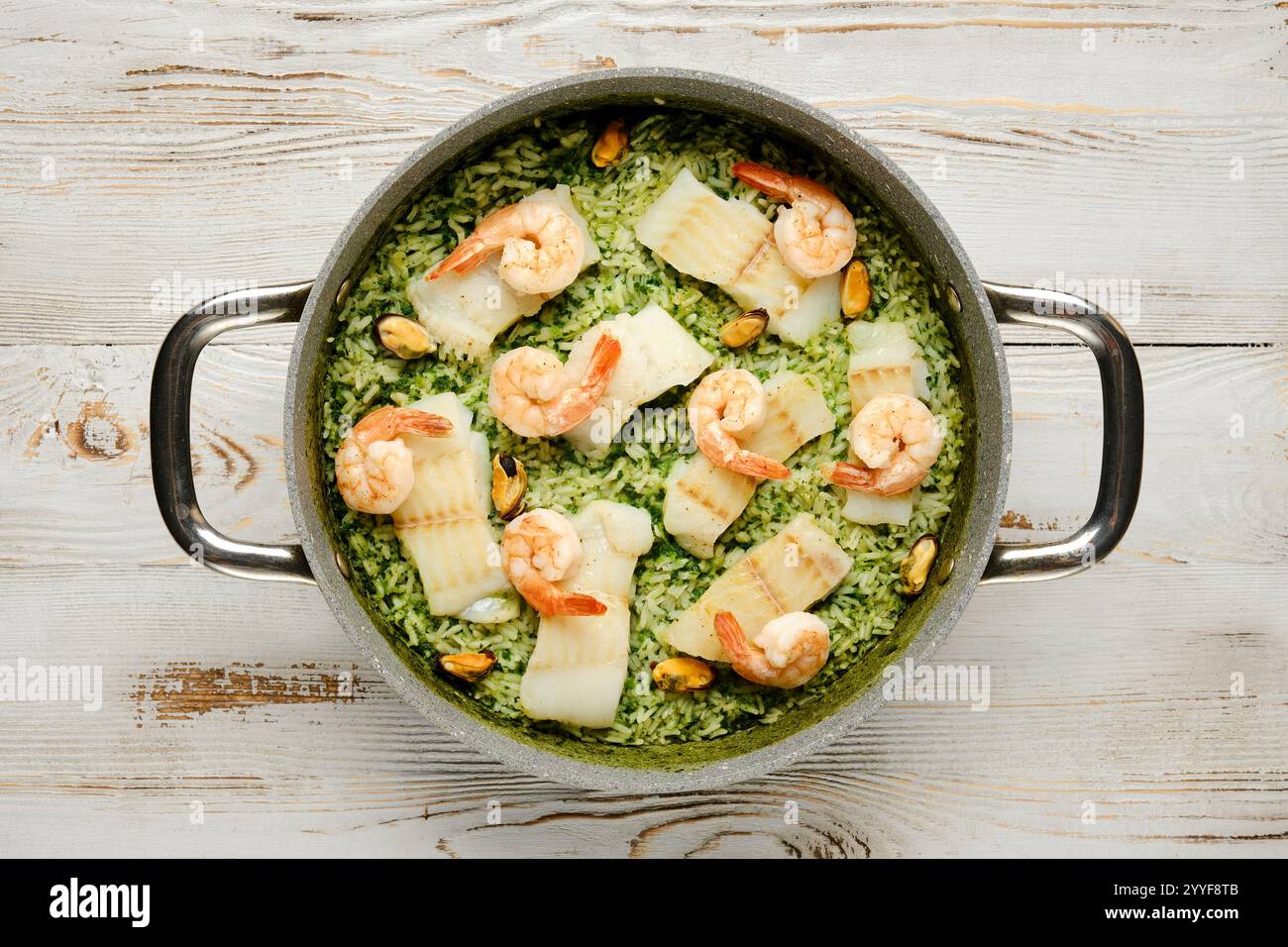A culinary delight showcases shrimp and fish layered over a vibrant ...
