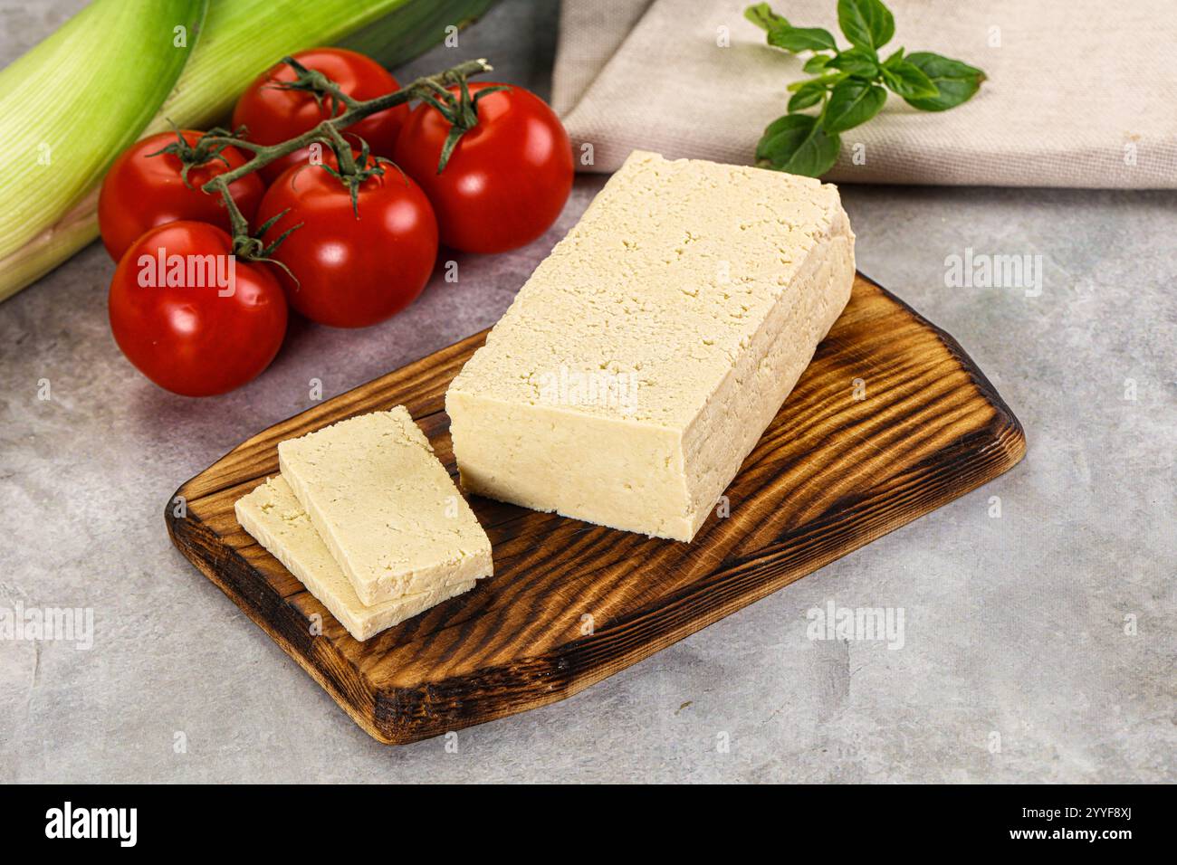 Soya vegan tofu cheese brick over board Stock Photo - Alamy