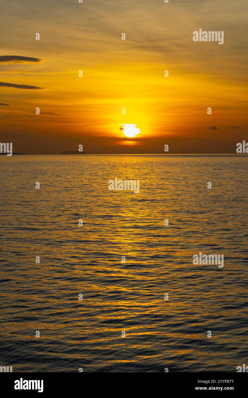 The setting sun lighting up the horizon an orangey reddish hue Stock ...