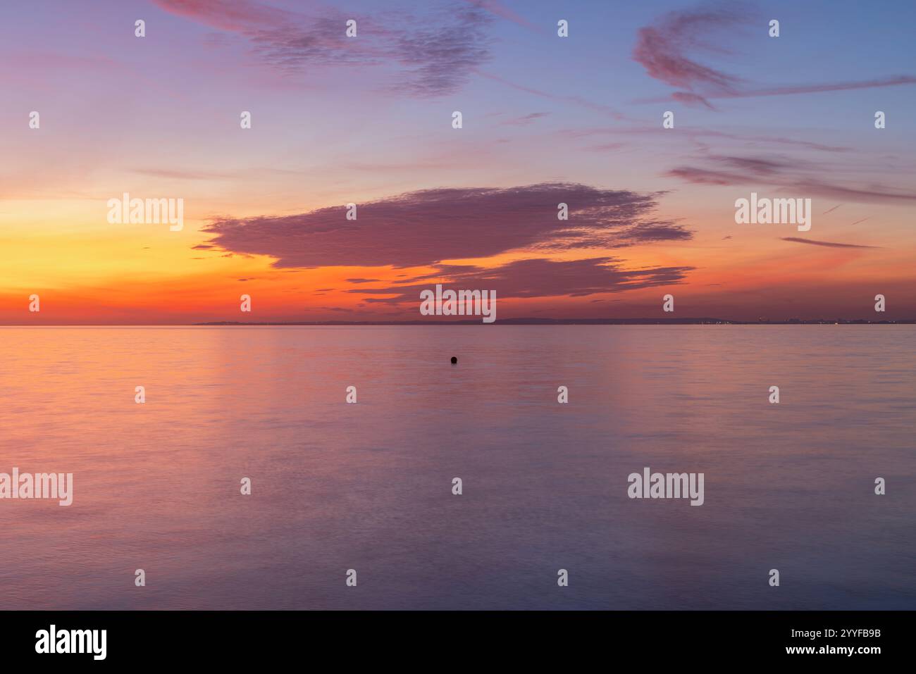 The reddish orangey colour along the horizon and the pink above ...