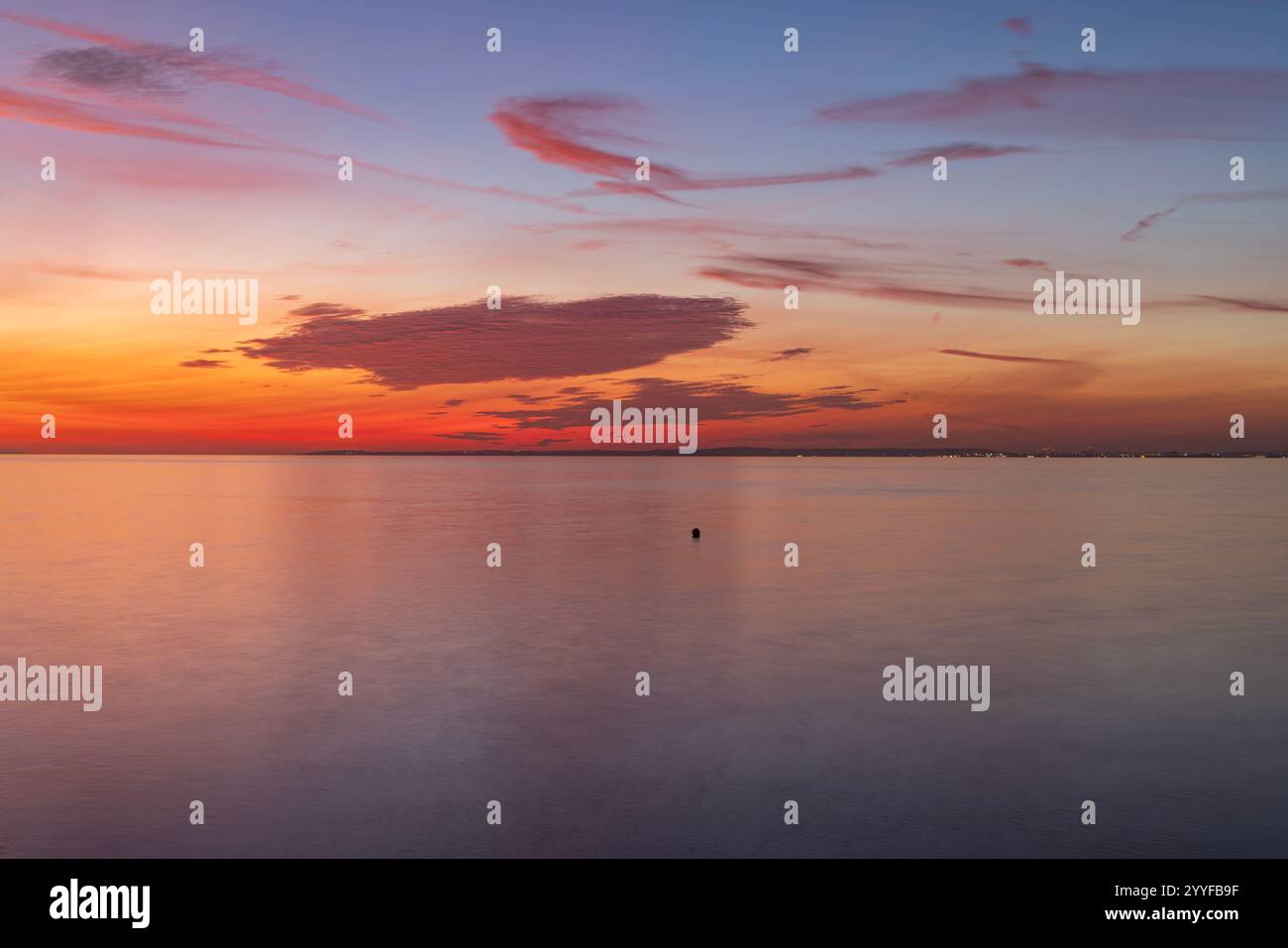 The reddish orangey colour along the horizon and the pink above ...