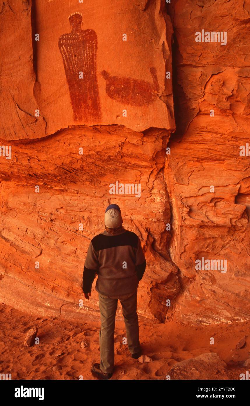 Hiker at ‘Crowned Figure’ pictograph, Barrier Canyon Style, at Hog ...