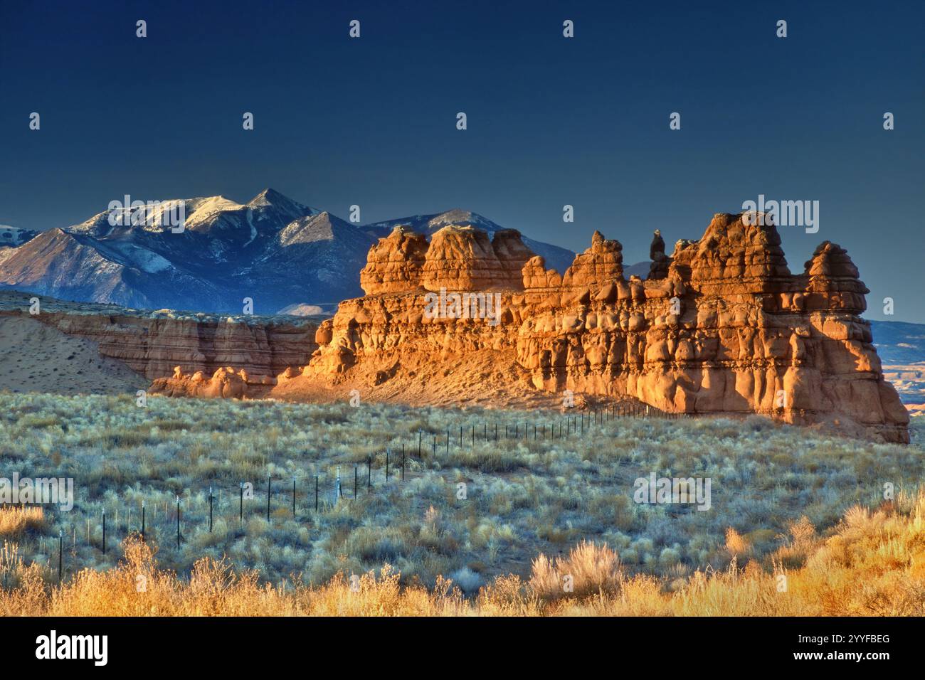 Sandstone rocks near Hwy 24, Henry Mountains in distance, San Rafael ...