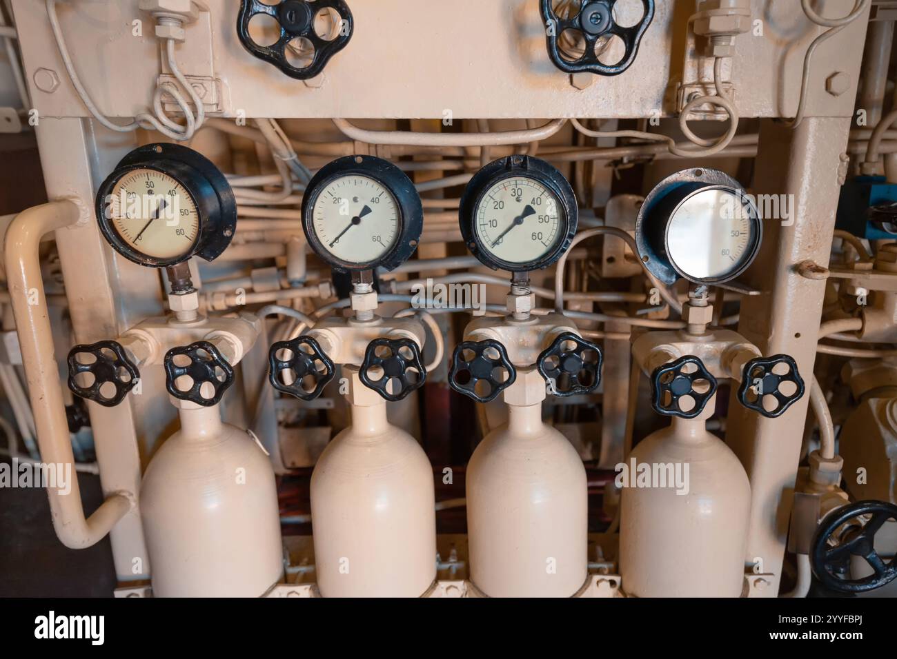 Complex control panel featuring valves, gauges, and tanks, highlighting ...
