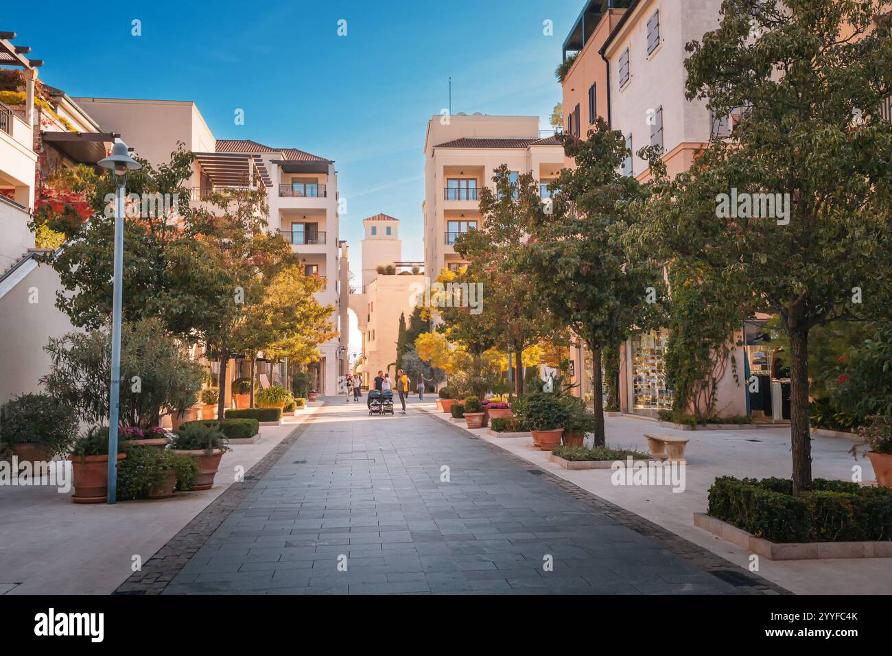 26 October 2024, Tivat, Montenegro: People strolling down a picturesque ...