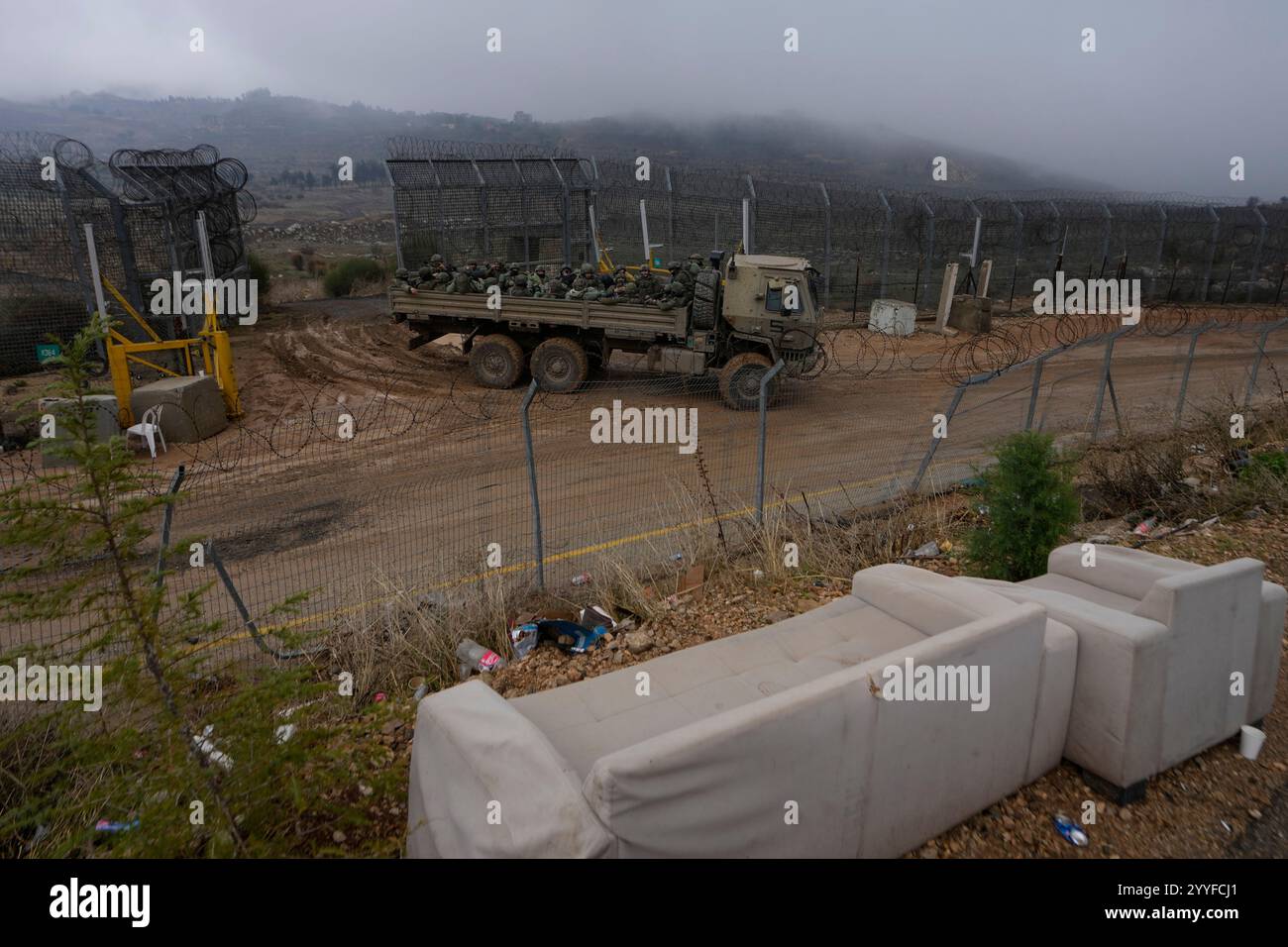 Israeli soldiers stand on an armoured vehicle after crossing the ...