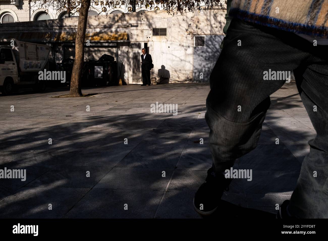 Young Greek boy skateboarding under the watchful eye of the Hotel Great ...