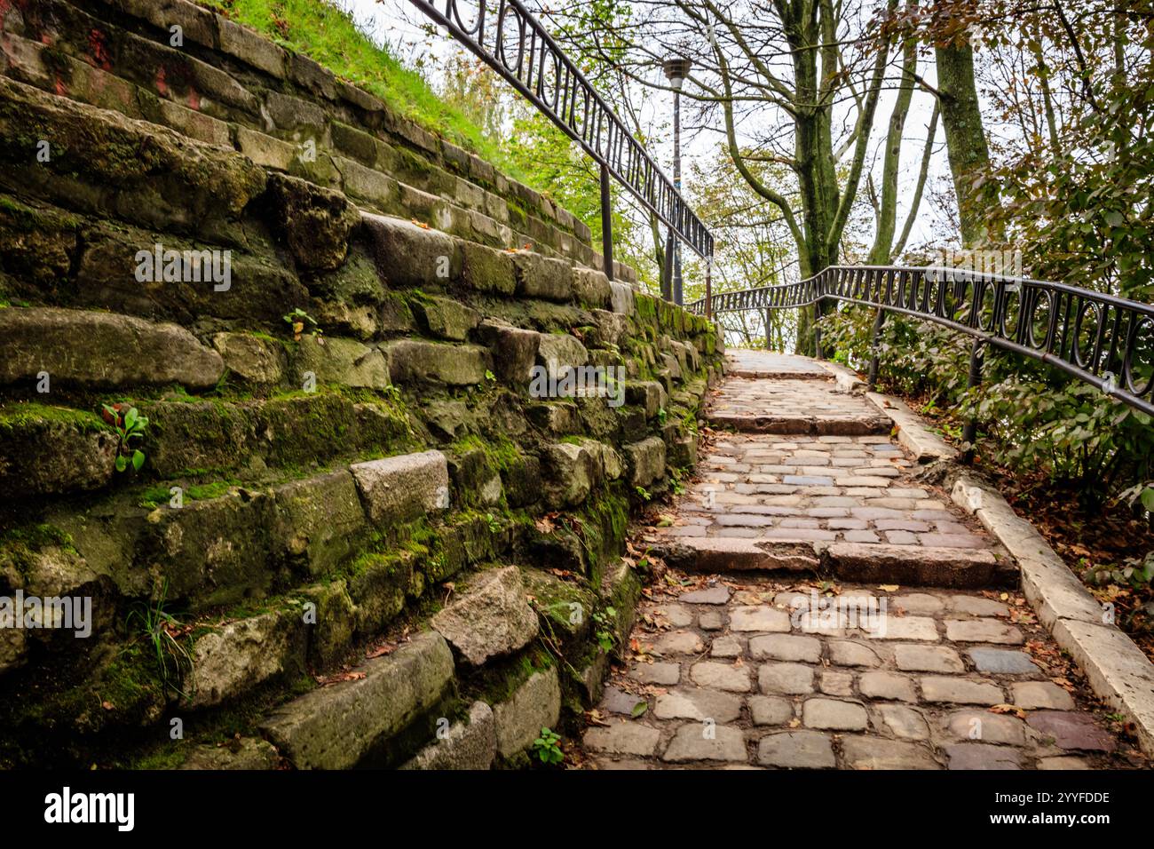 A stone wall with a stone staircase leading up to it. The wall is ...