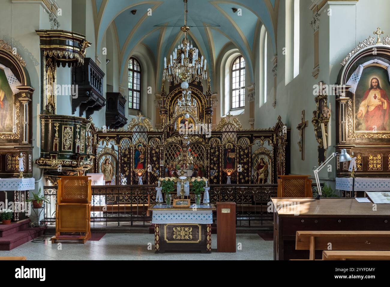 The interior of a church is decorated with many paintings and statues ...