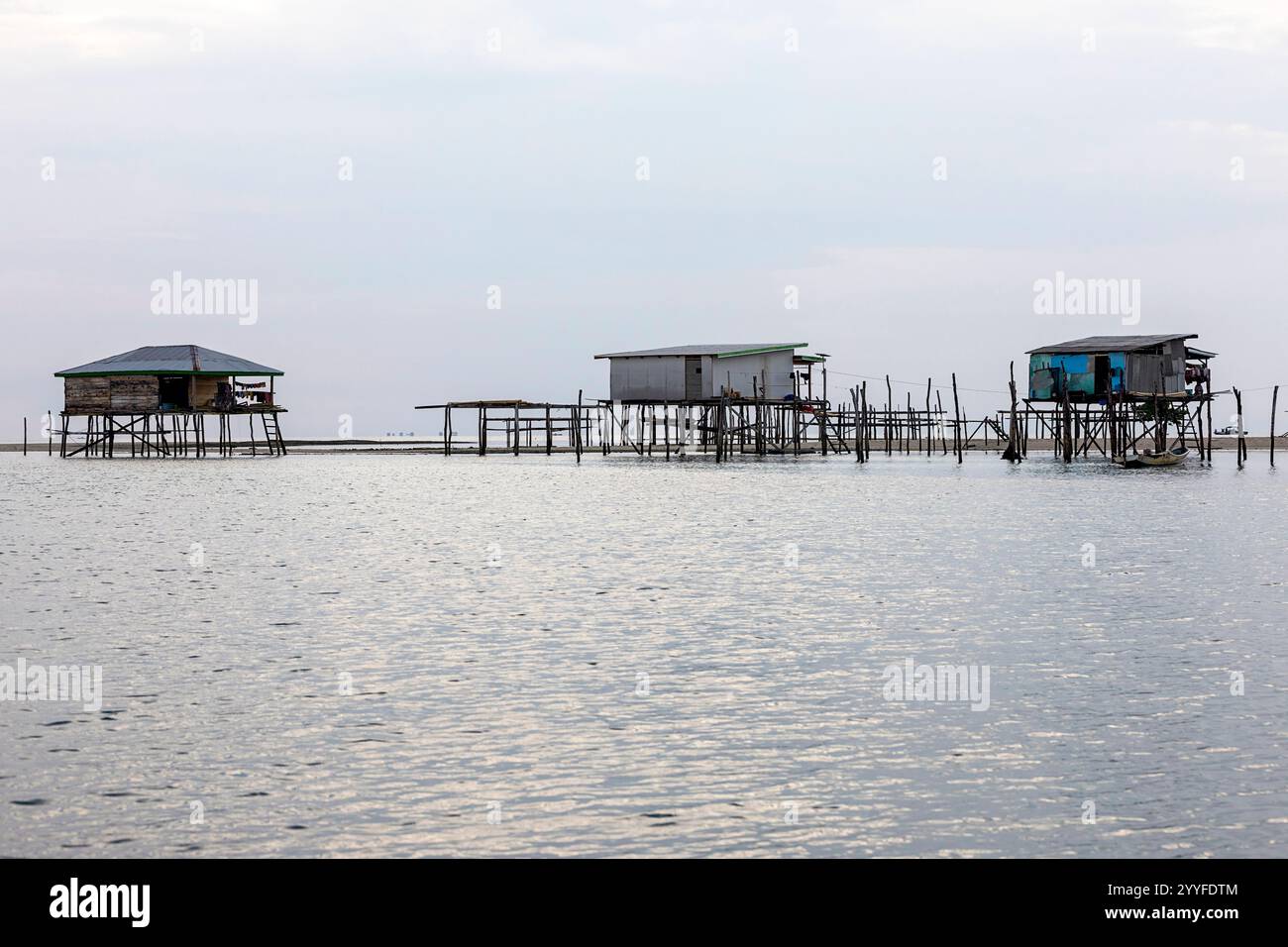 Wooden Houses on stilts, traditional bajau village in the middle of a ...