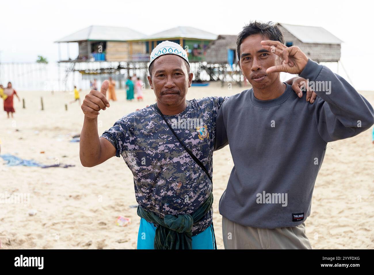 Portrait of two bajau men, fishermen friends in a small village in the ...