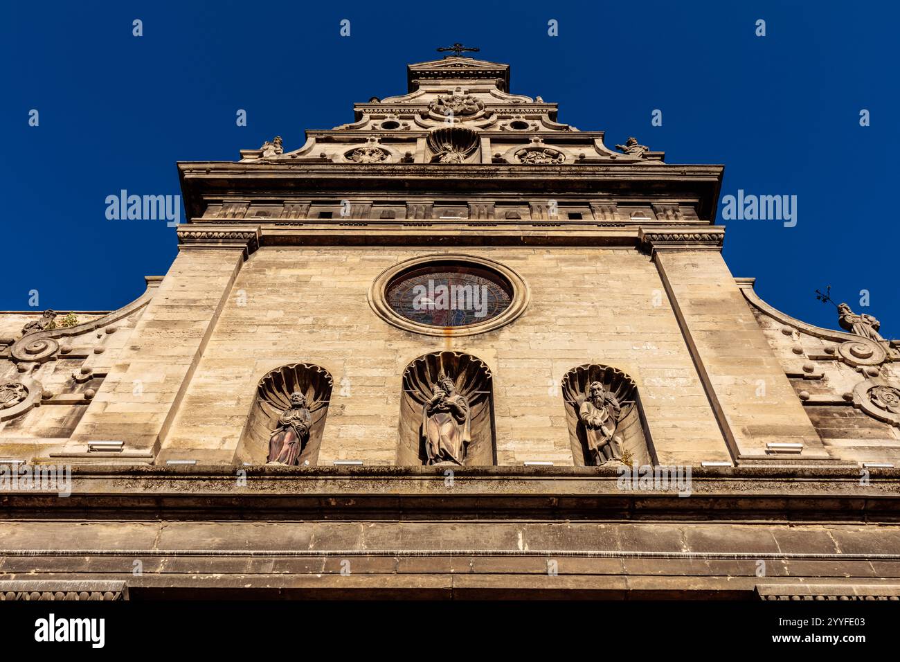 The church has a large stained glass window. The window is surrounded ...