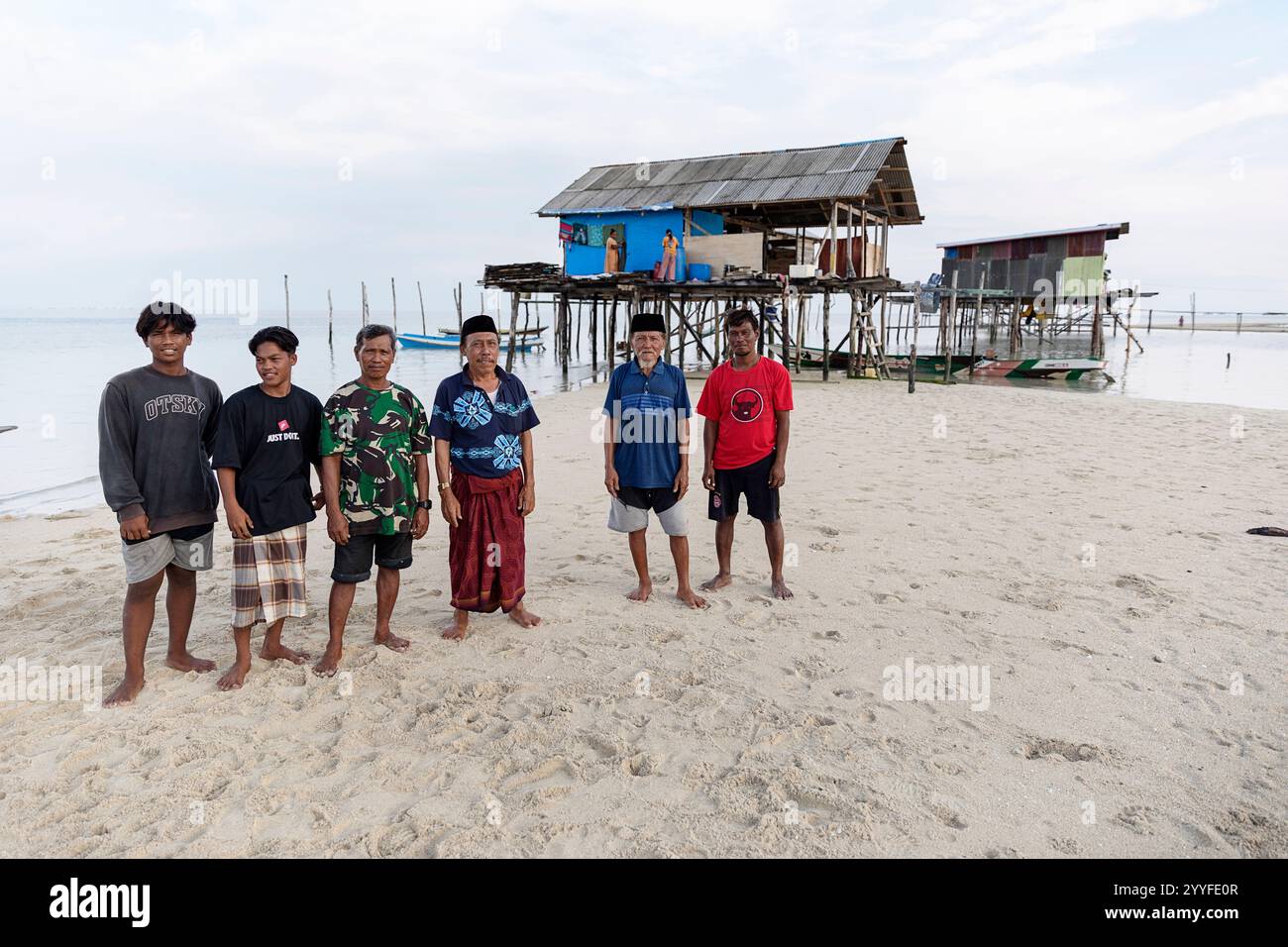 Portrait of a group of bajau men in small village in the middle of a ...