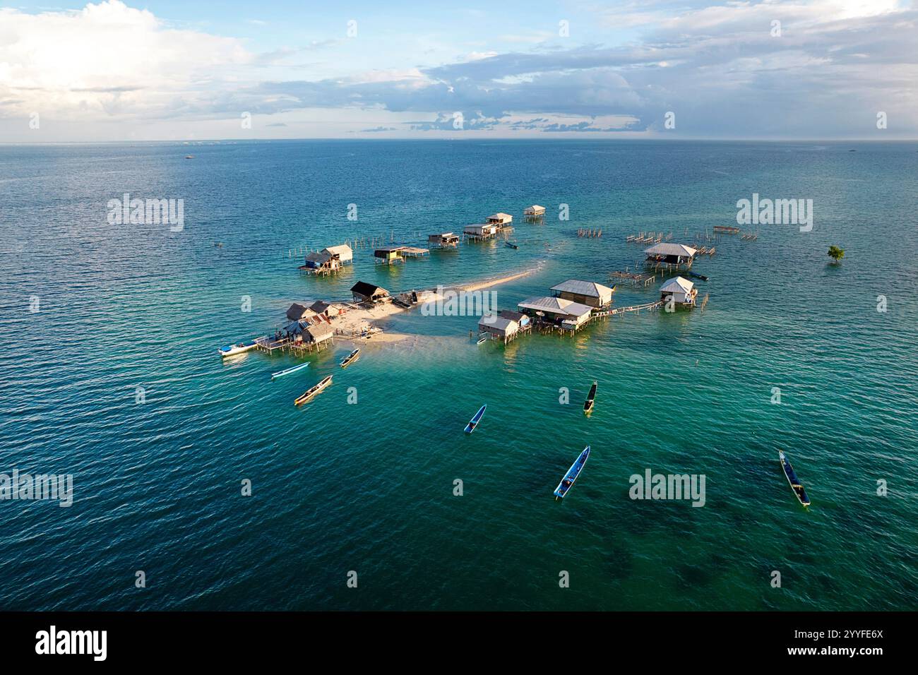 Aerial view of a bajau laut village, houses on stilts and dugout canoes ...