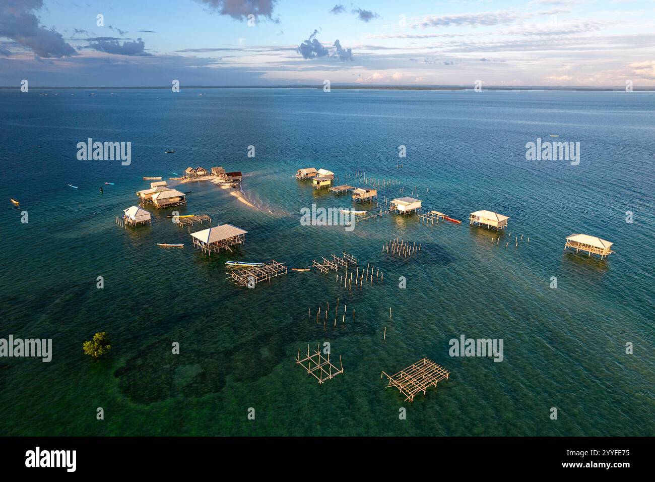 Aerial view of a bajau laut village, houses on stilts and dugout canoes ...