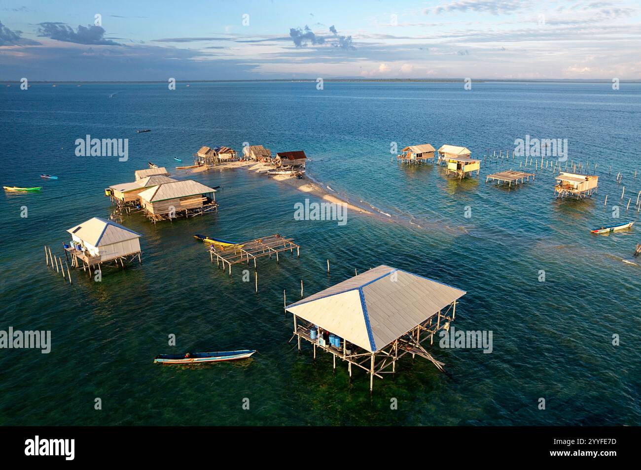 Aerial view of a bajau laut village, houses on stilts and dugout canoes ...