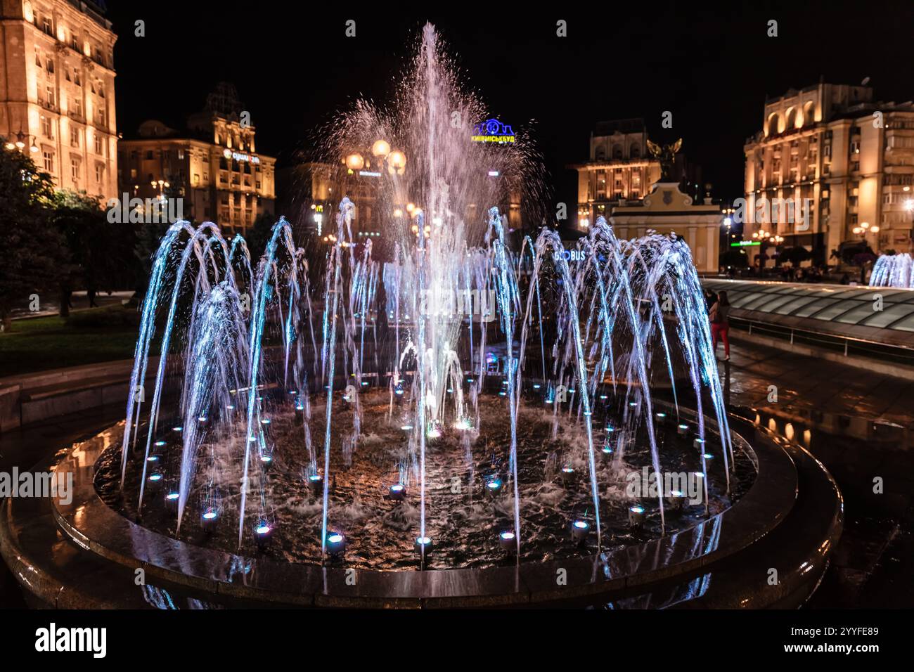 A large fountain with many jets of water shooting out of it. The water ...