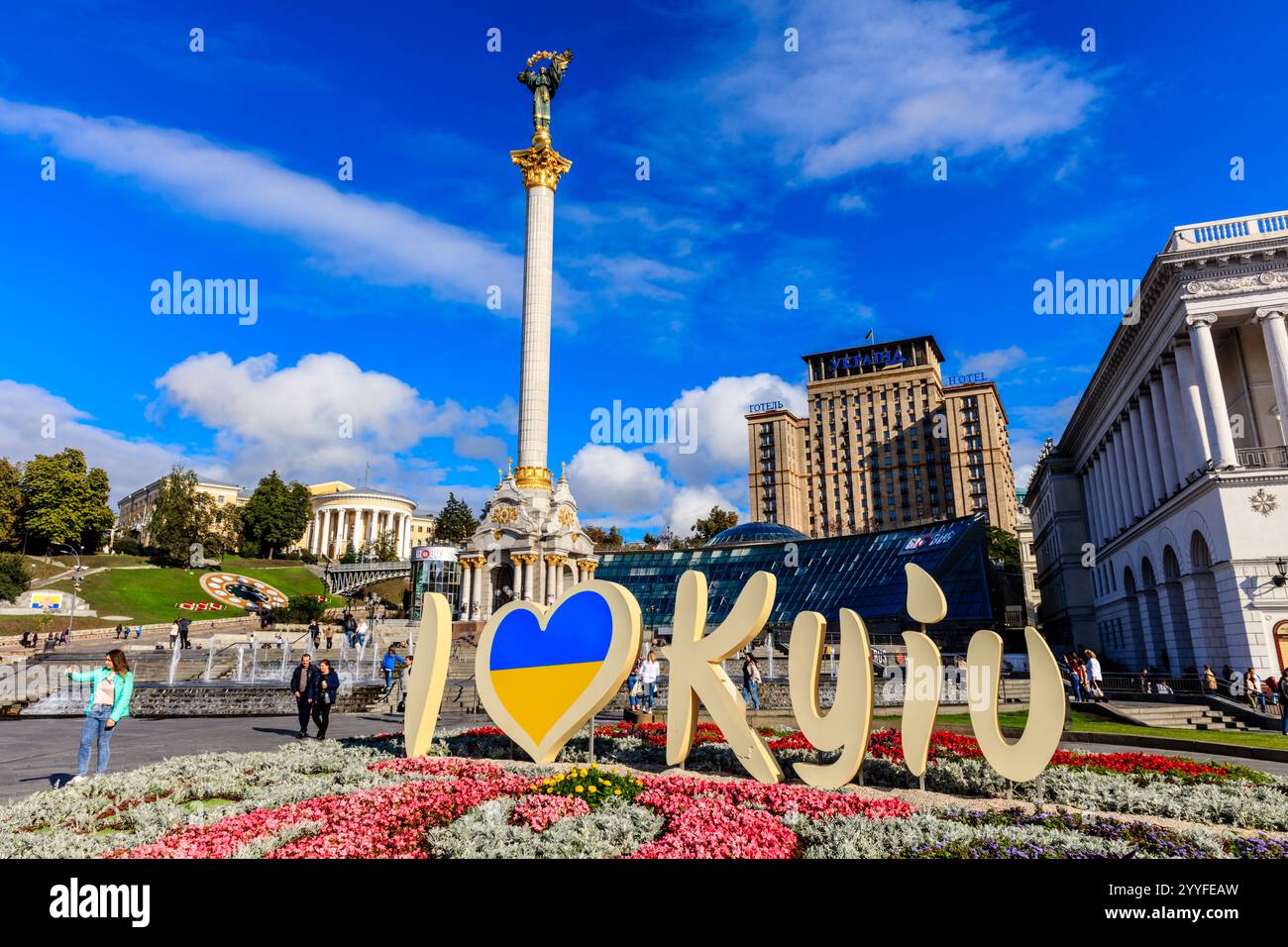 A large, white, gold and blue statue of a woman holding a sword is in ...