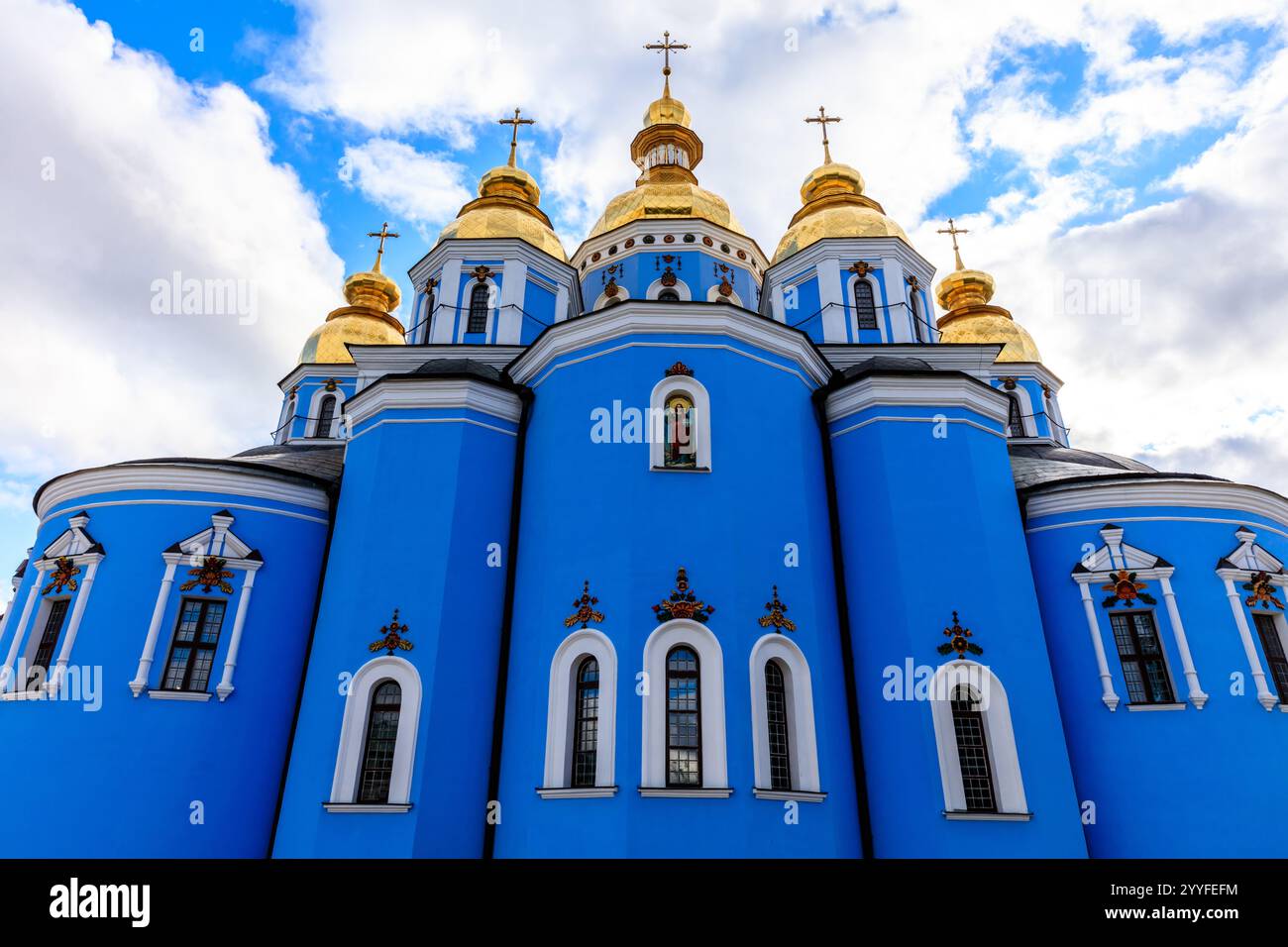 A large blue church with gold domes and crosses. The building is very ...
