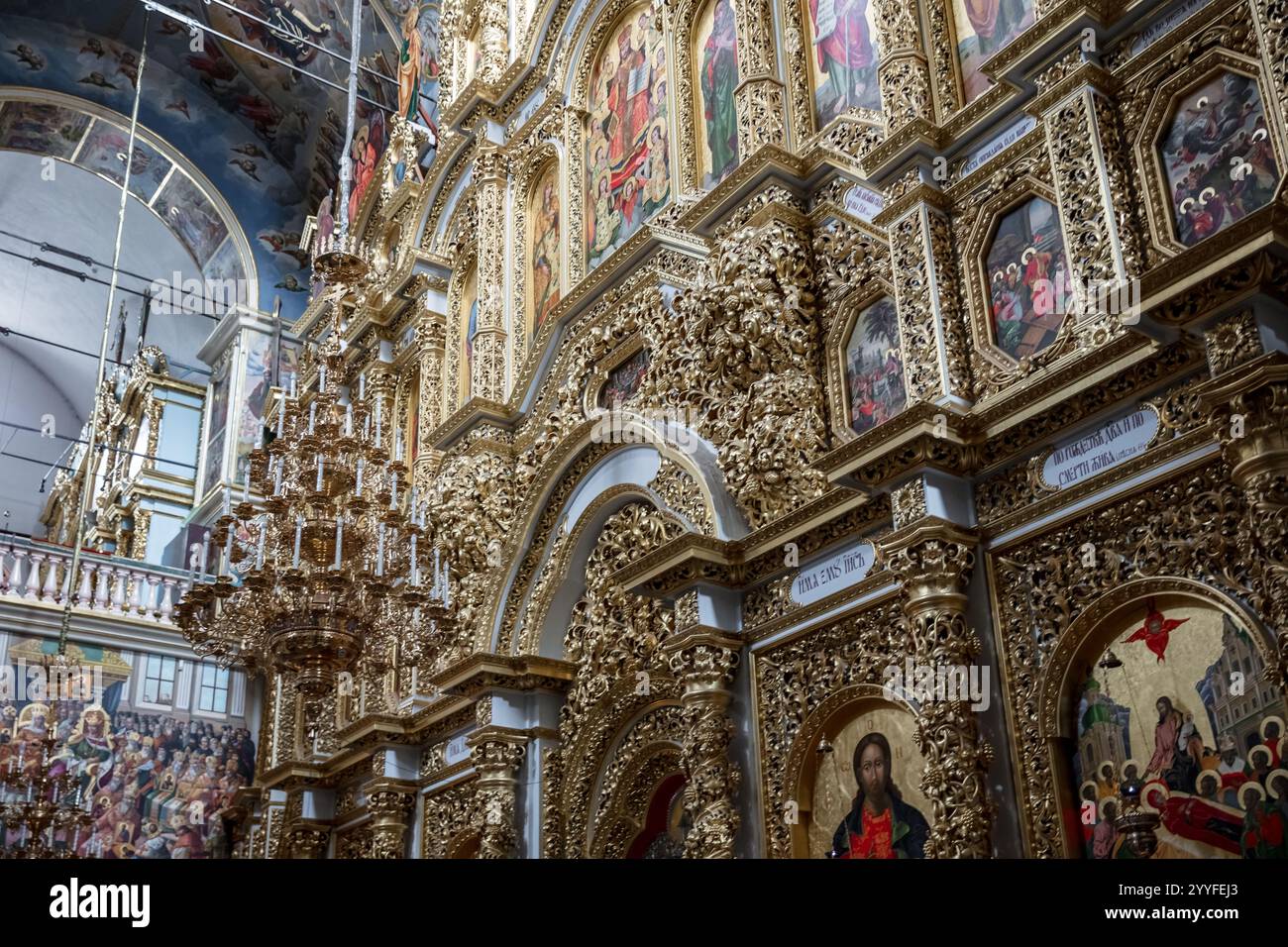 The gold and white church is filled with religious paintings and ...