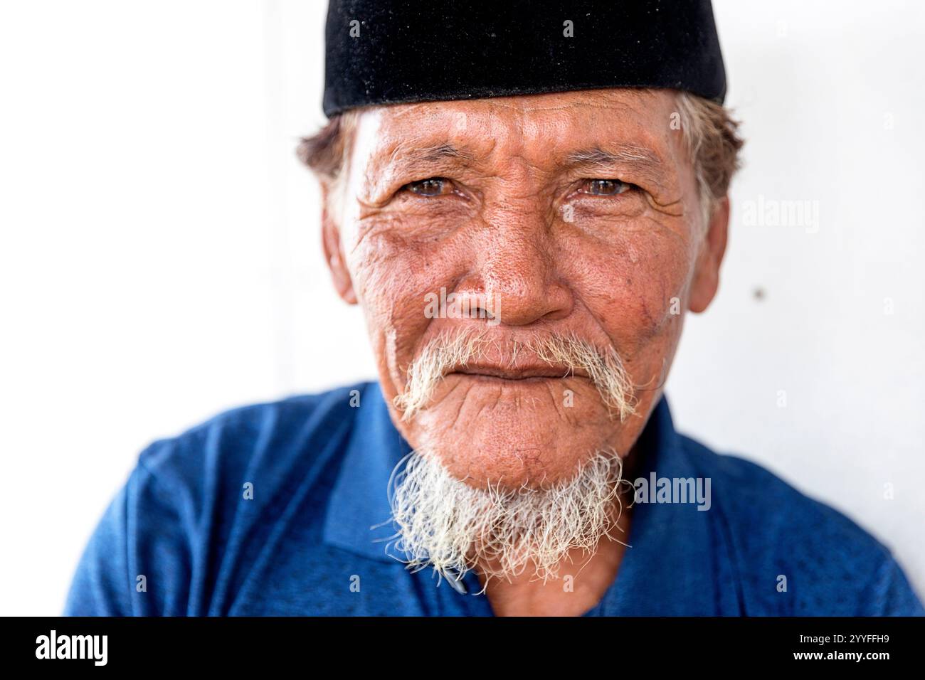Portrait of Old man in traditional clothes with traditional hat posing ...