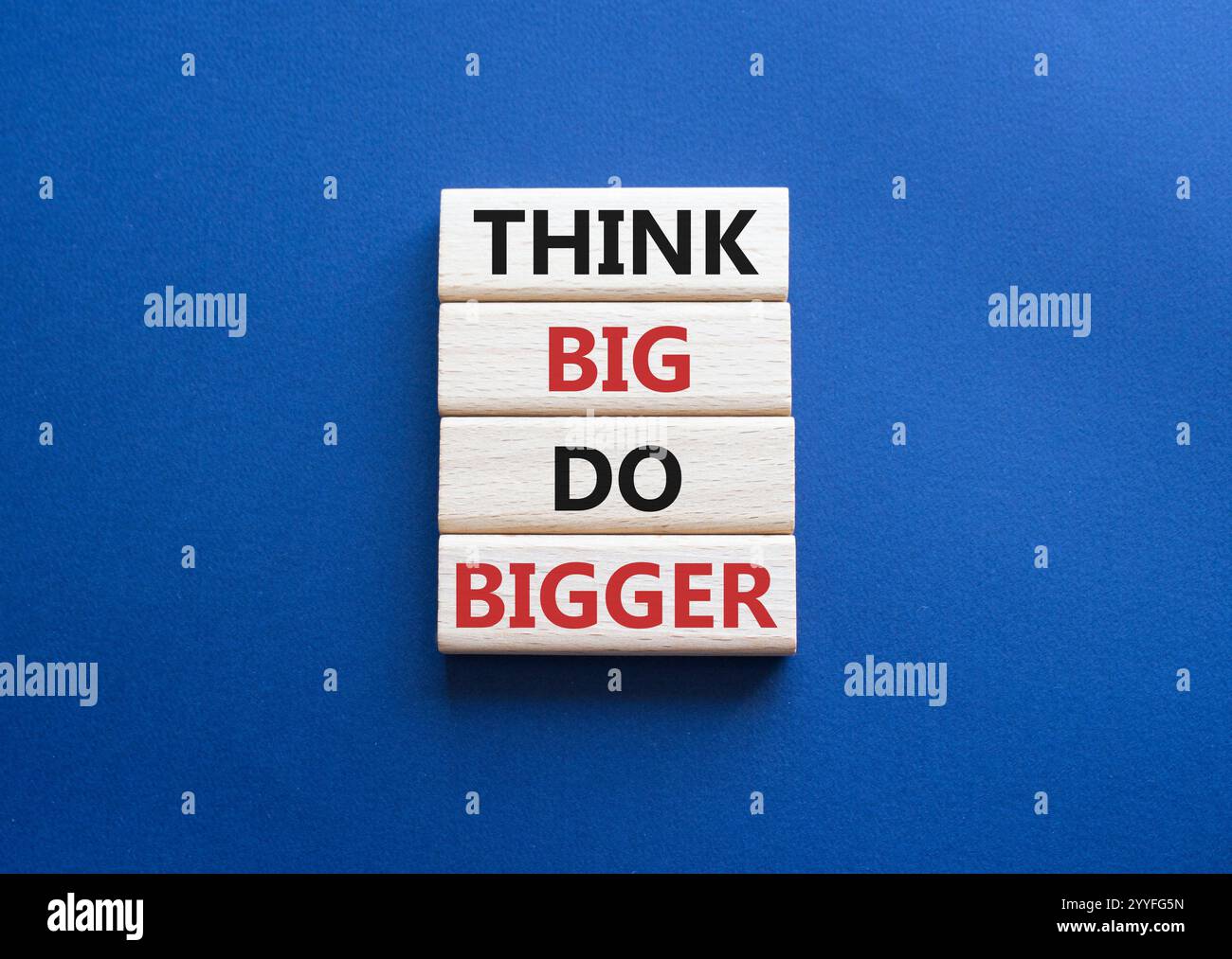 Think Big Do Bigger symbol. Wooden blocks with words Think Big Do ...