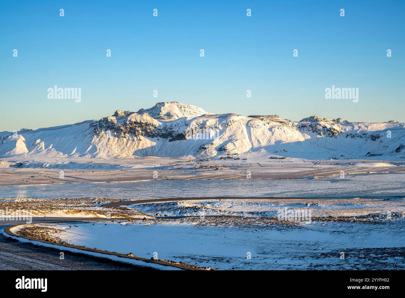 Ice and snow covered Icelandic roads and snow capped mountains in the ...