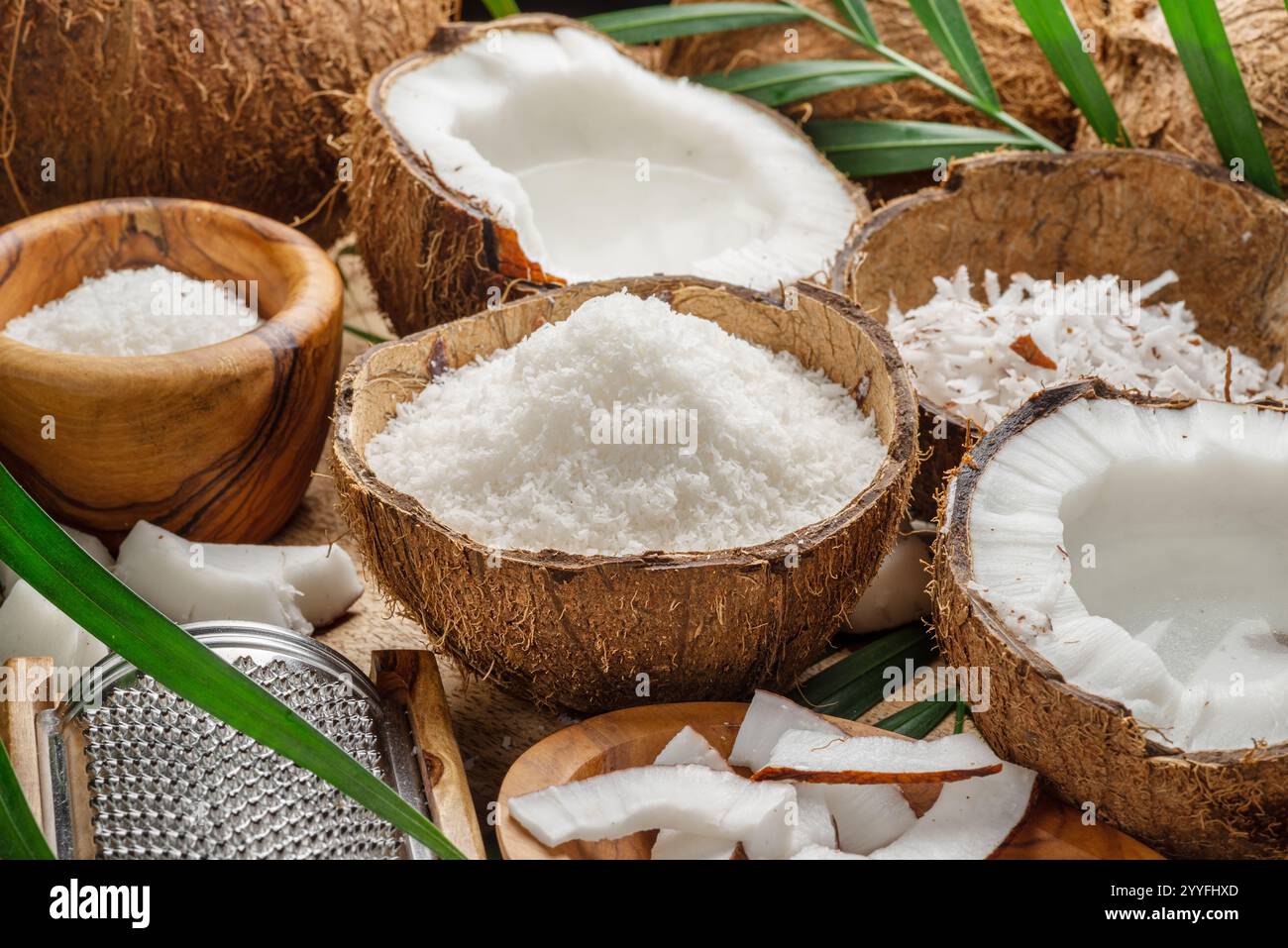 Fresh opened coconuts along with coconut slices, flakes and coconut ...