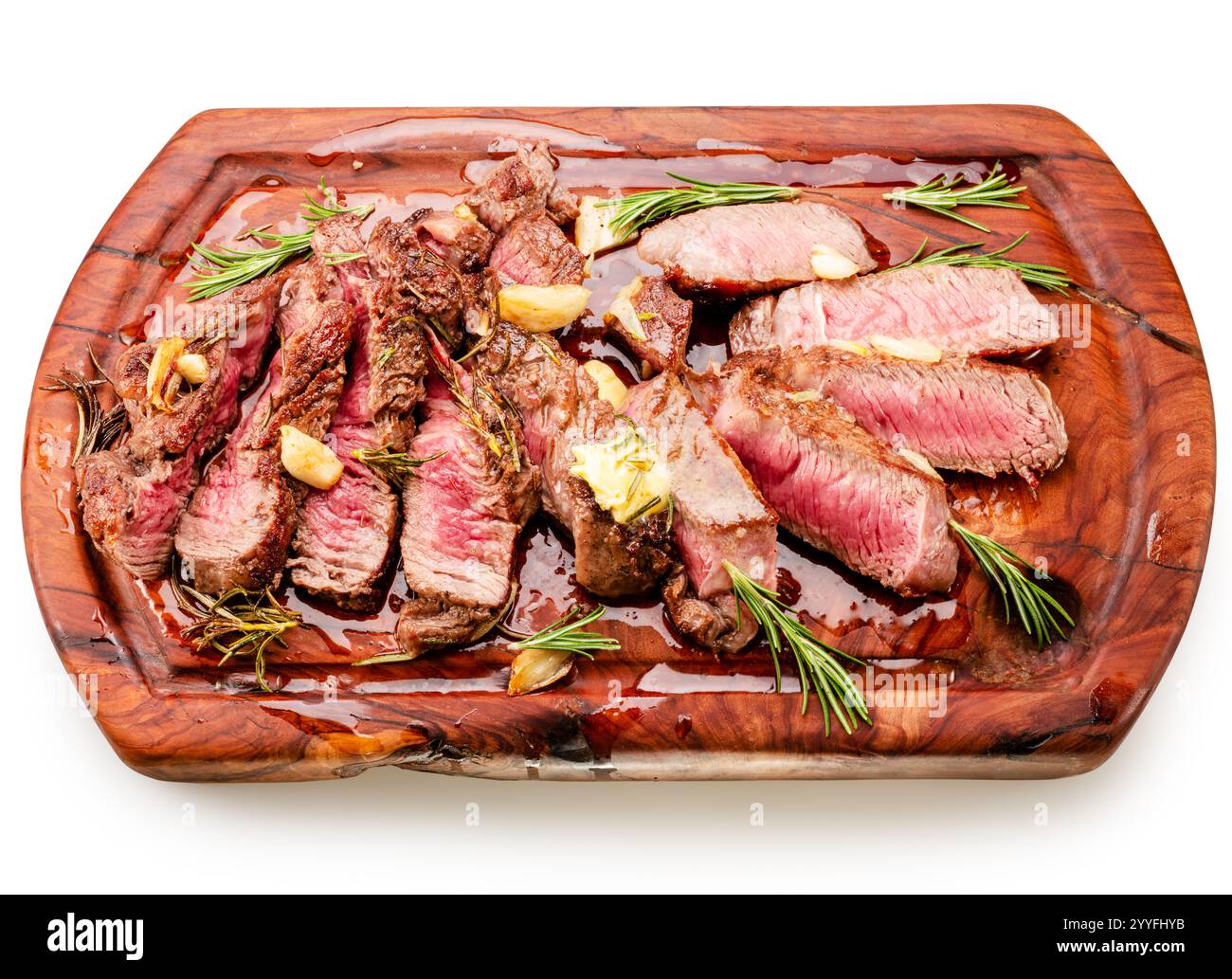 Sliced juicy medium rib eye steak on wooden board top view isolated on ...