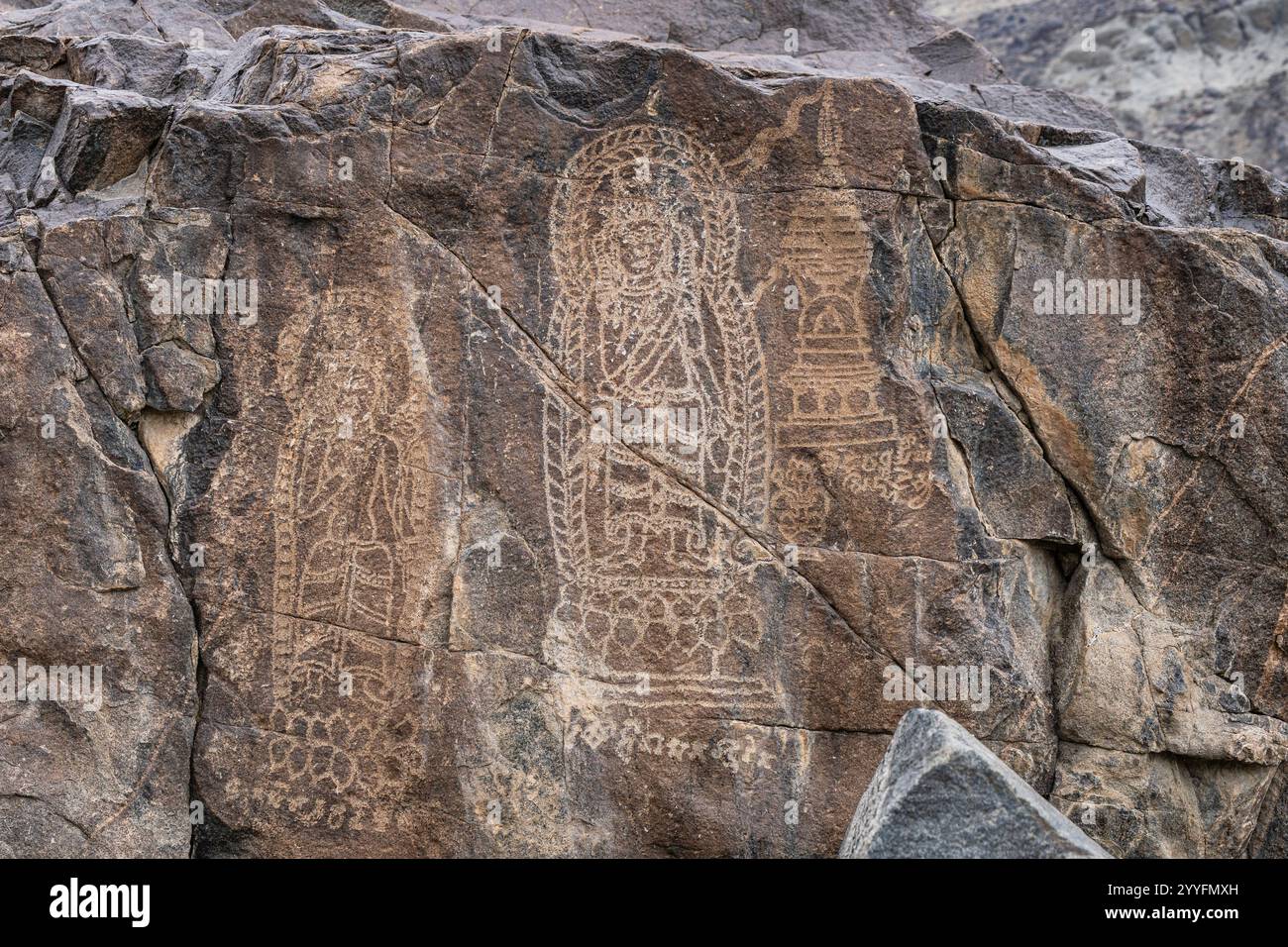 View of historic buddhist petroglyphs carved on rock on ancient silk ...
