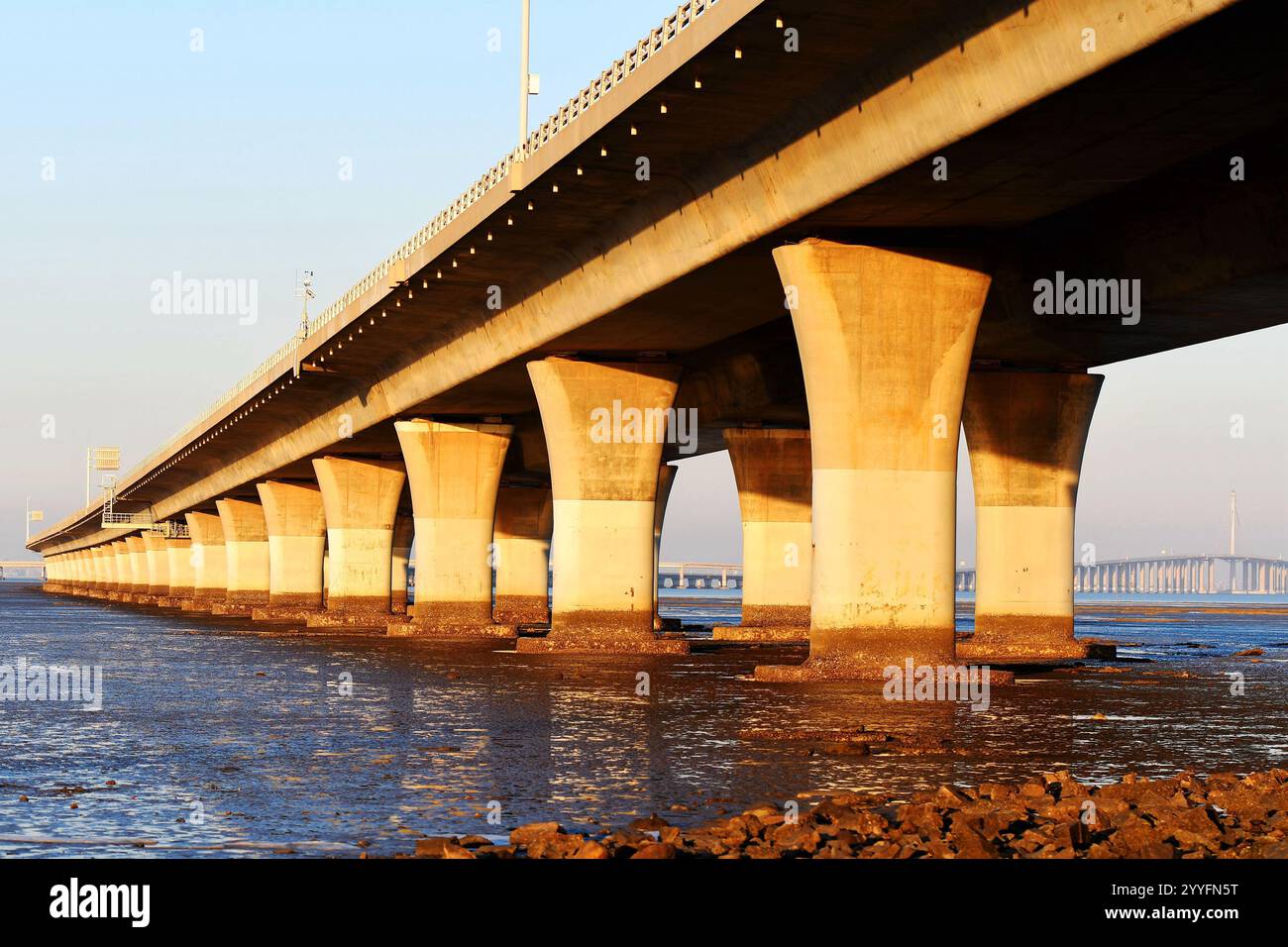 QINGDAO, CHINA - DECEMBER 22, 2024 - The sunset light passes under the ...