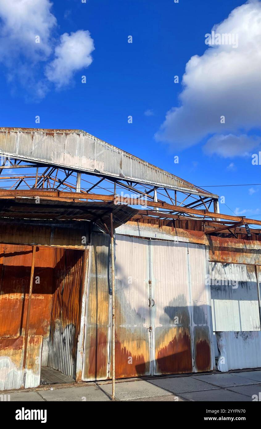 warehouse with a loading ramp after a fire. Burnt metal frame of the ...