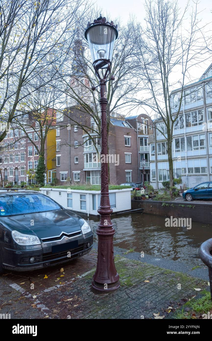 Street lamp on the sidewalk beside the canal in Amsterdam, Netherlands ...