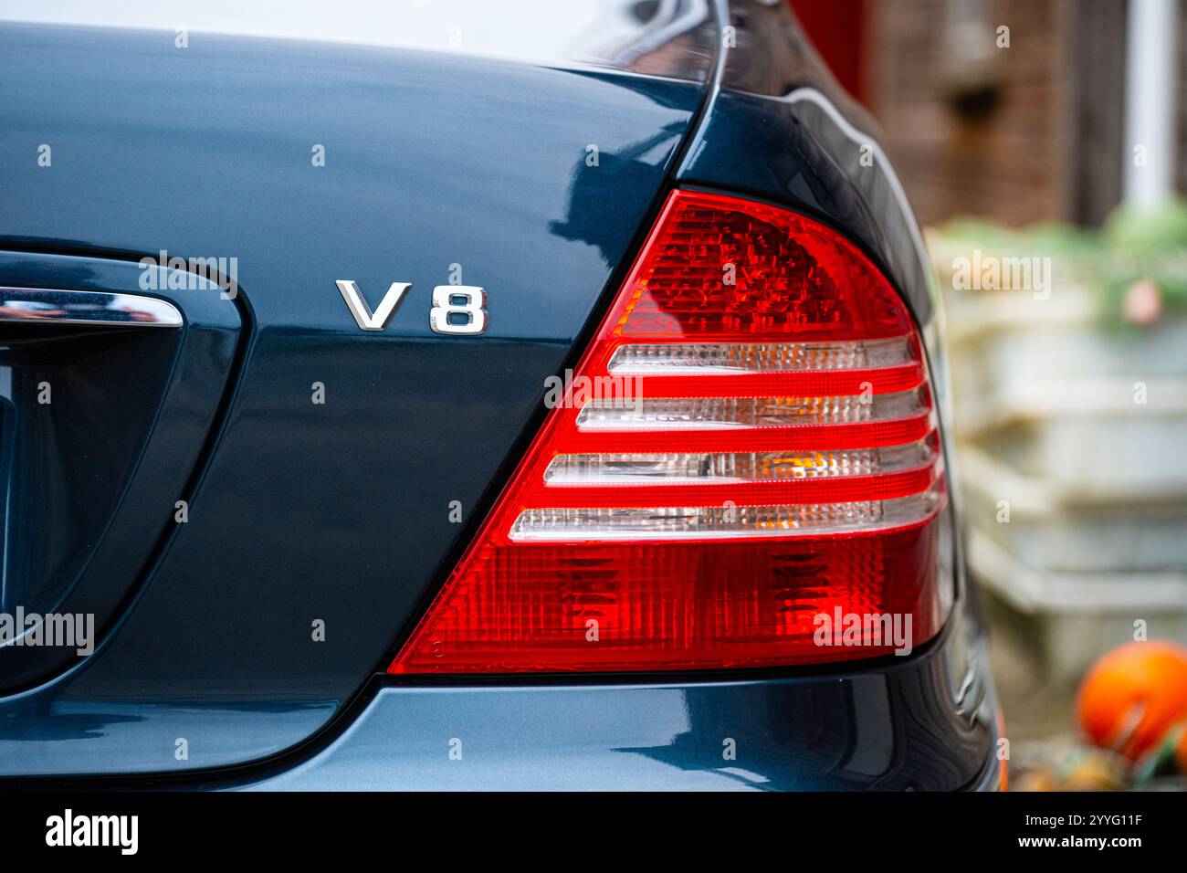 V8 marking on the trunk lid of a dark blue car Stock Photo - Alamy