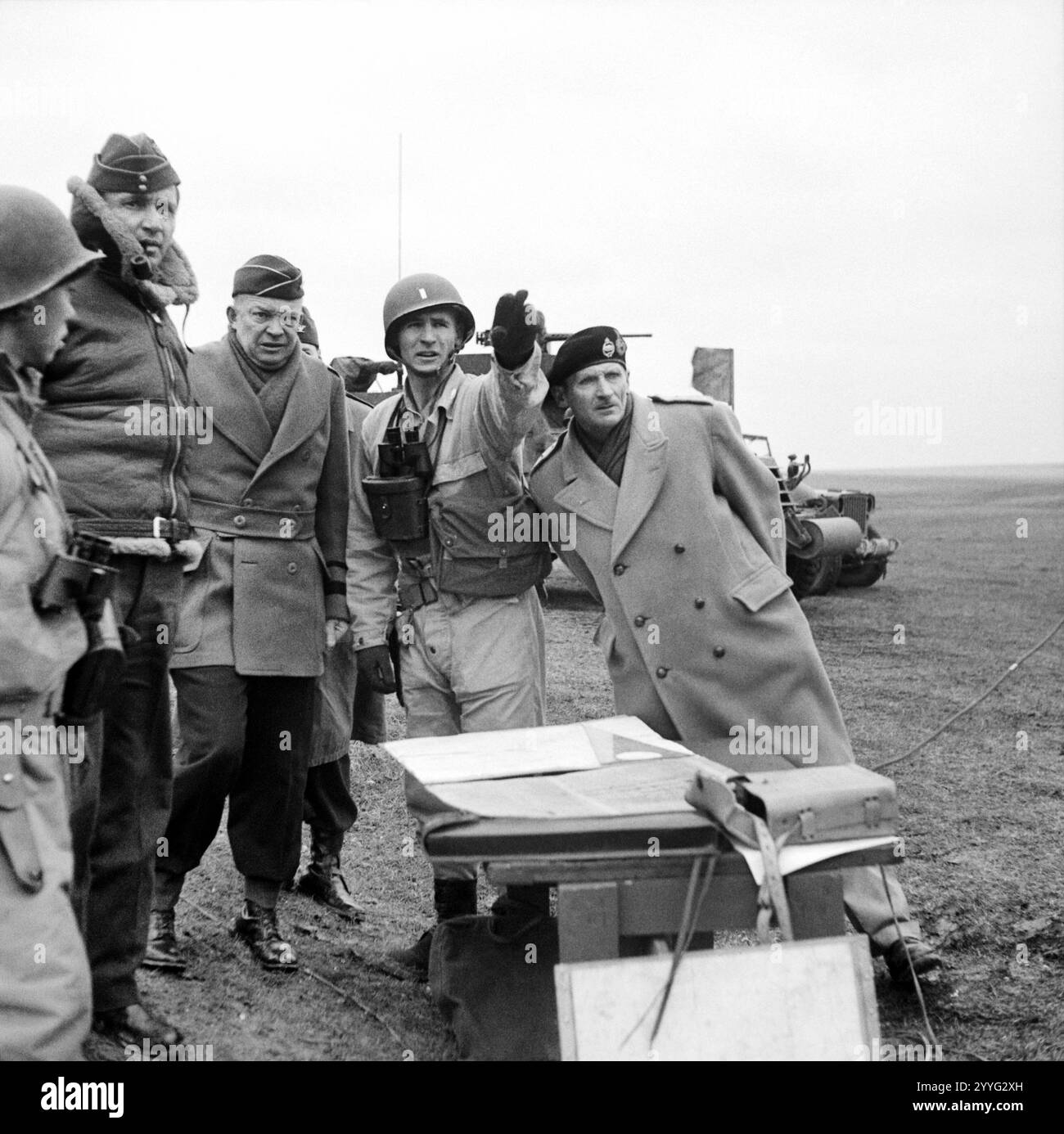A US tank officer points out the target to senior Allied commanders ...