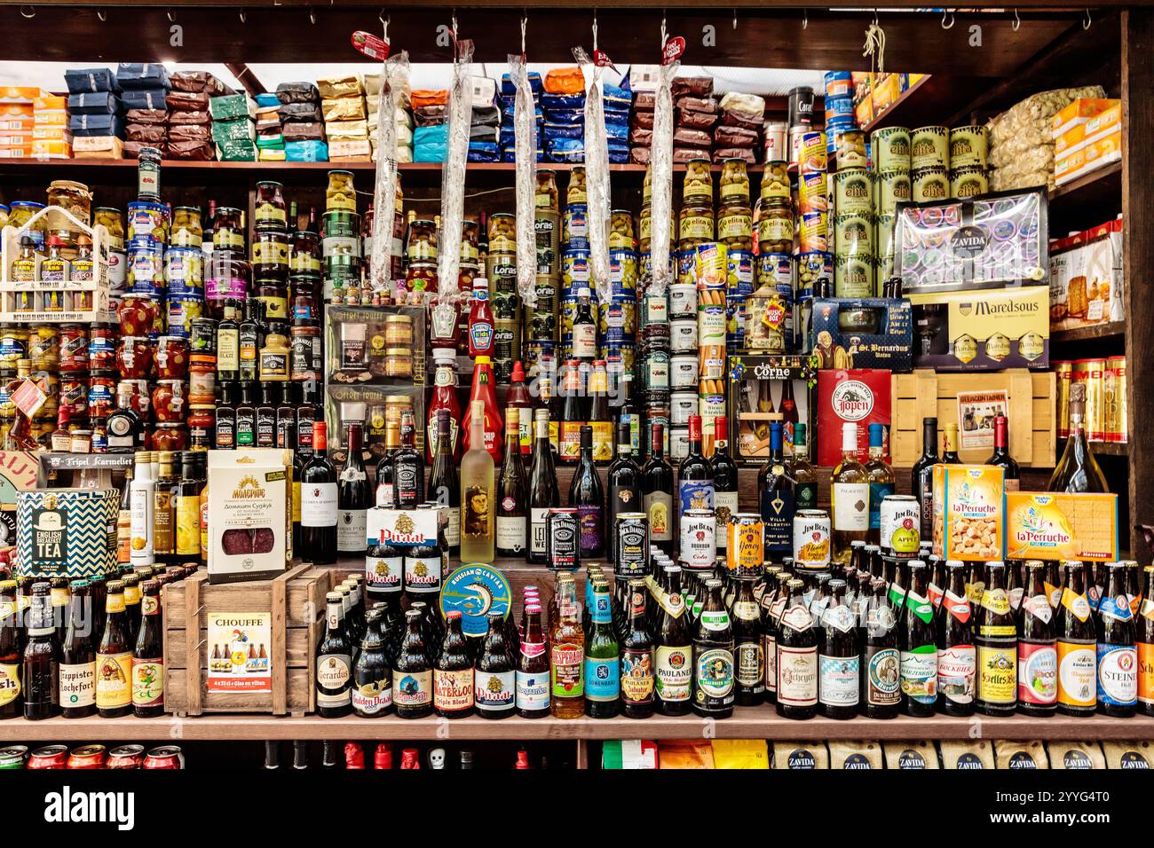 A store with many bottles of beer and other beverages. The bottles are ...