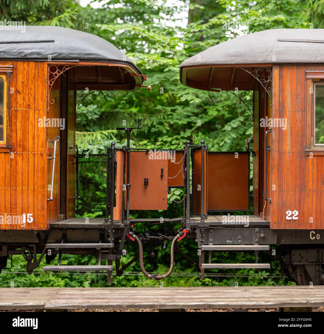 Two vintage wooden train cars at a station Stock Photo - Alamy