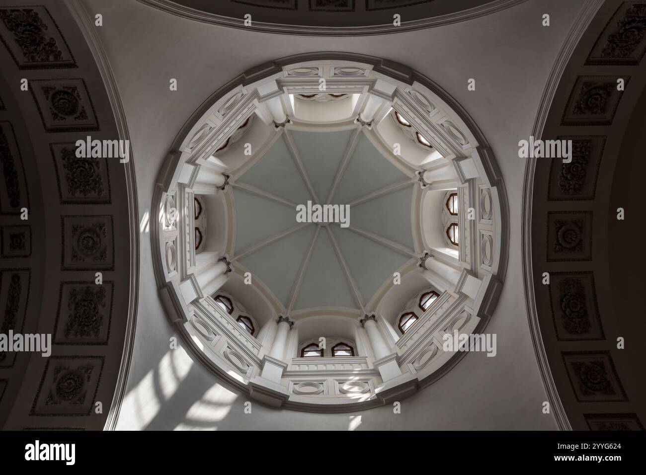 A large dome with a white ceiling. The dome is surrounded by windows ...